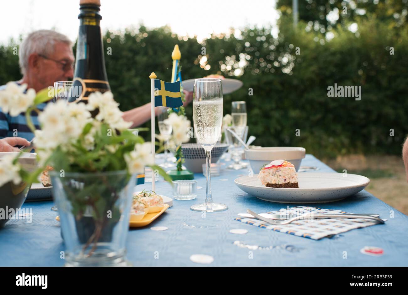 traditional Swedish food on a table outdoors celebrating midsummer ...