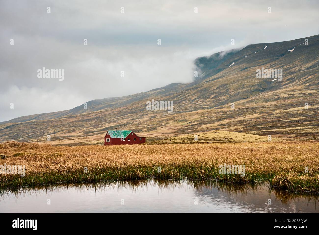 Small rural house in mountains near pond Stock Photo - Alamy