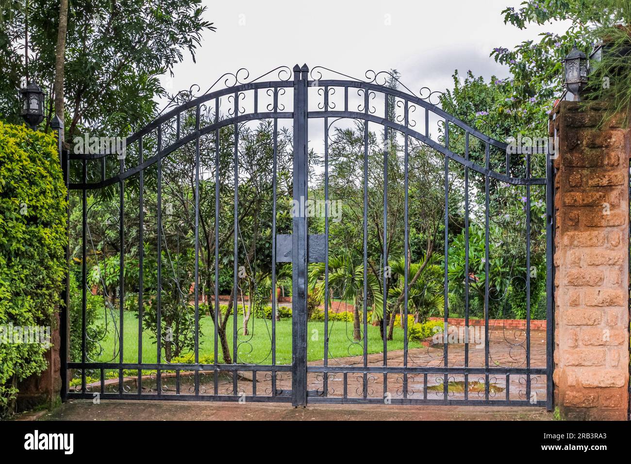 Home Main Gate metal attached to concrete Stock Photo - Alamy
