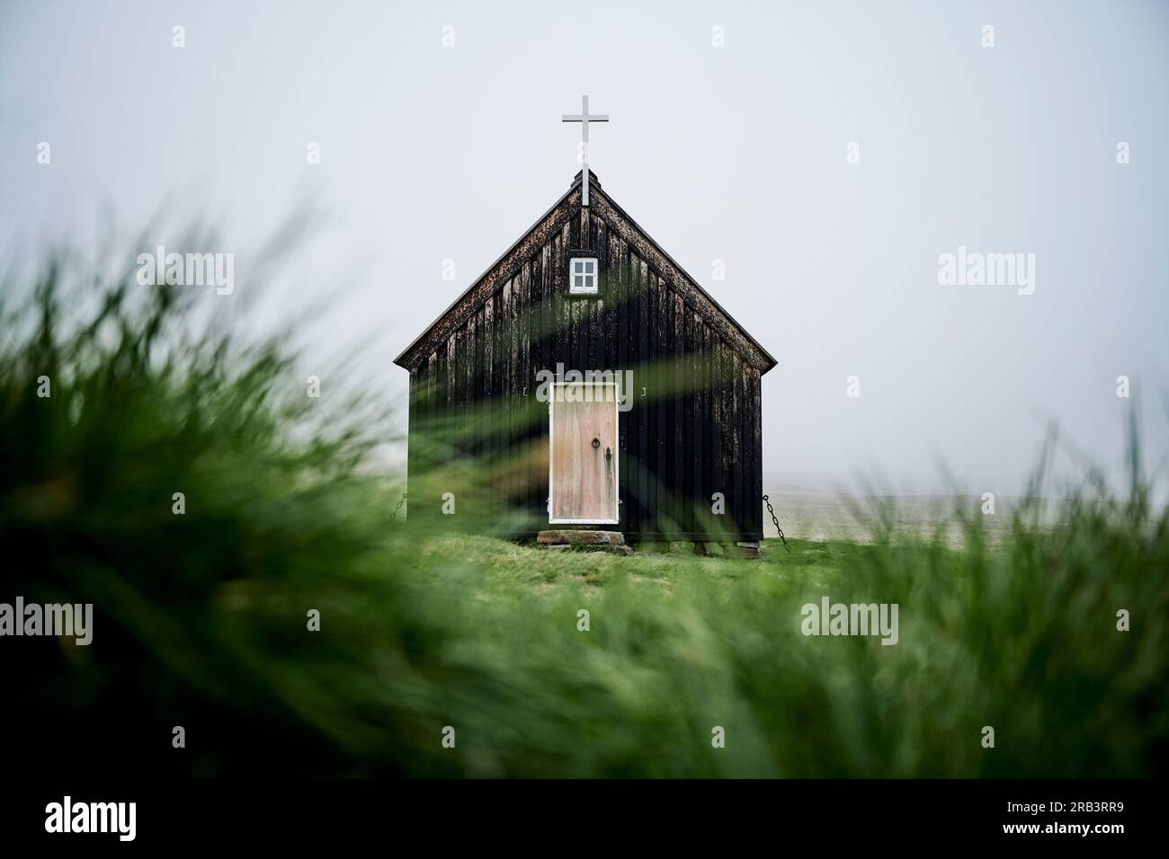 Small black church with cross on top of it Stock Photo - Alamy