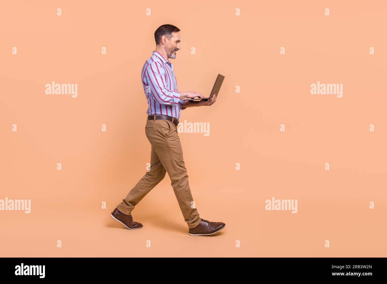 Full size profile photo of successful banker walking use wireless ...