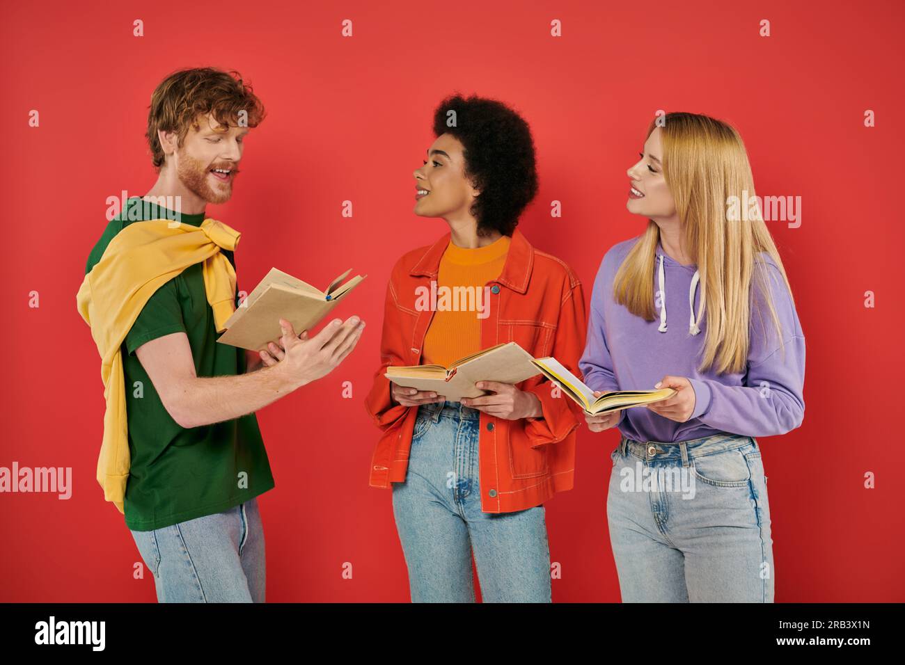 polygamy concept, three interracial lovers reading books on coral ...