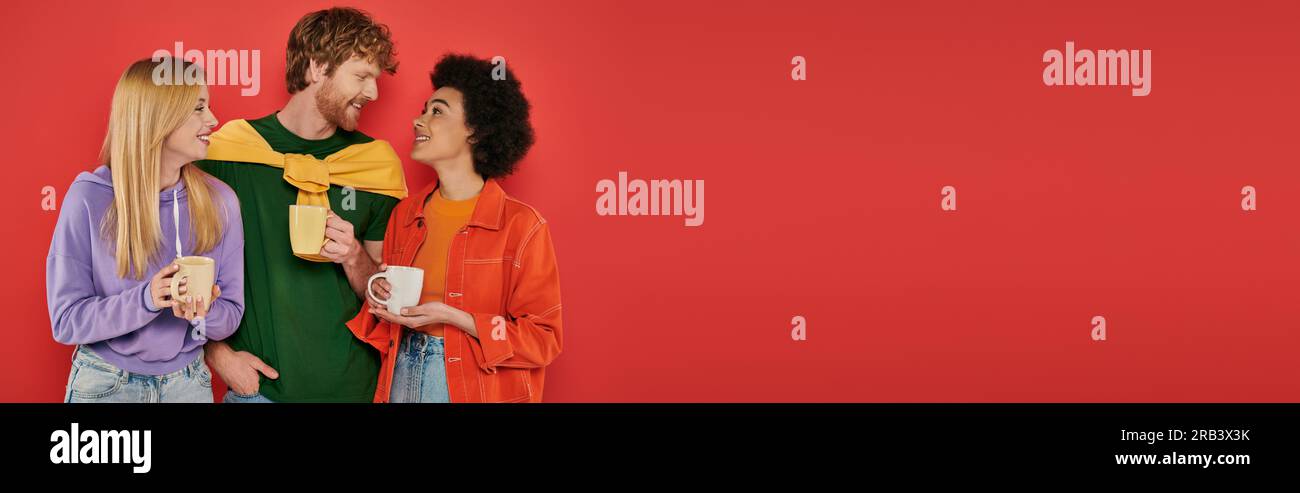 polygamy concept, young multicultural women and redhead man holding ...