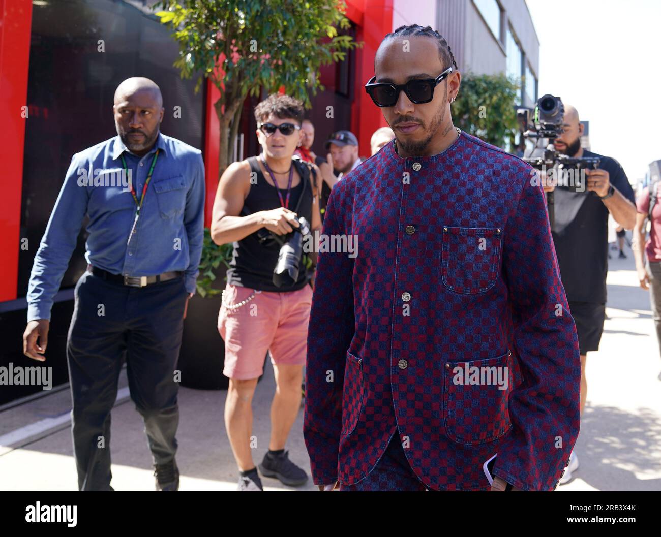 Lewis hamilton arrives in the paddock hi-res stock photography and ...