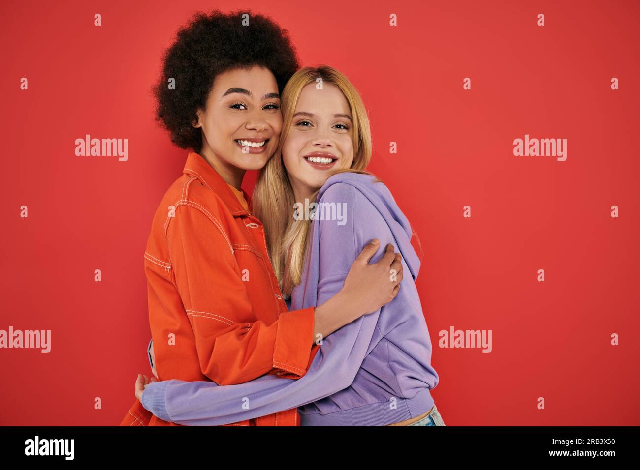 cultural diversity, cheerful multicultural women hugging while looking ...