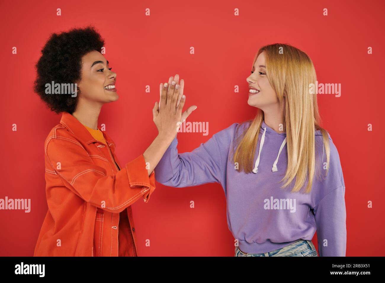cultural diversity, cheerful multicultural women giving high five on ...