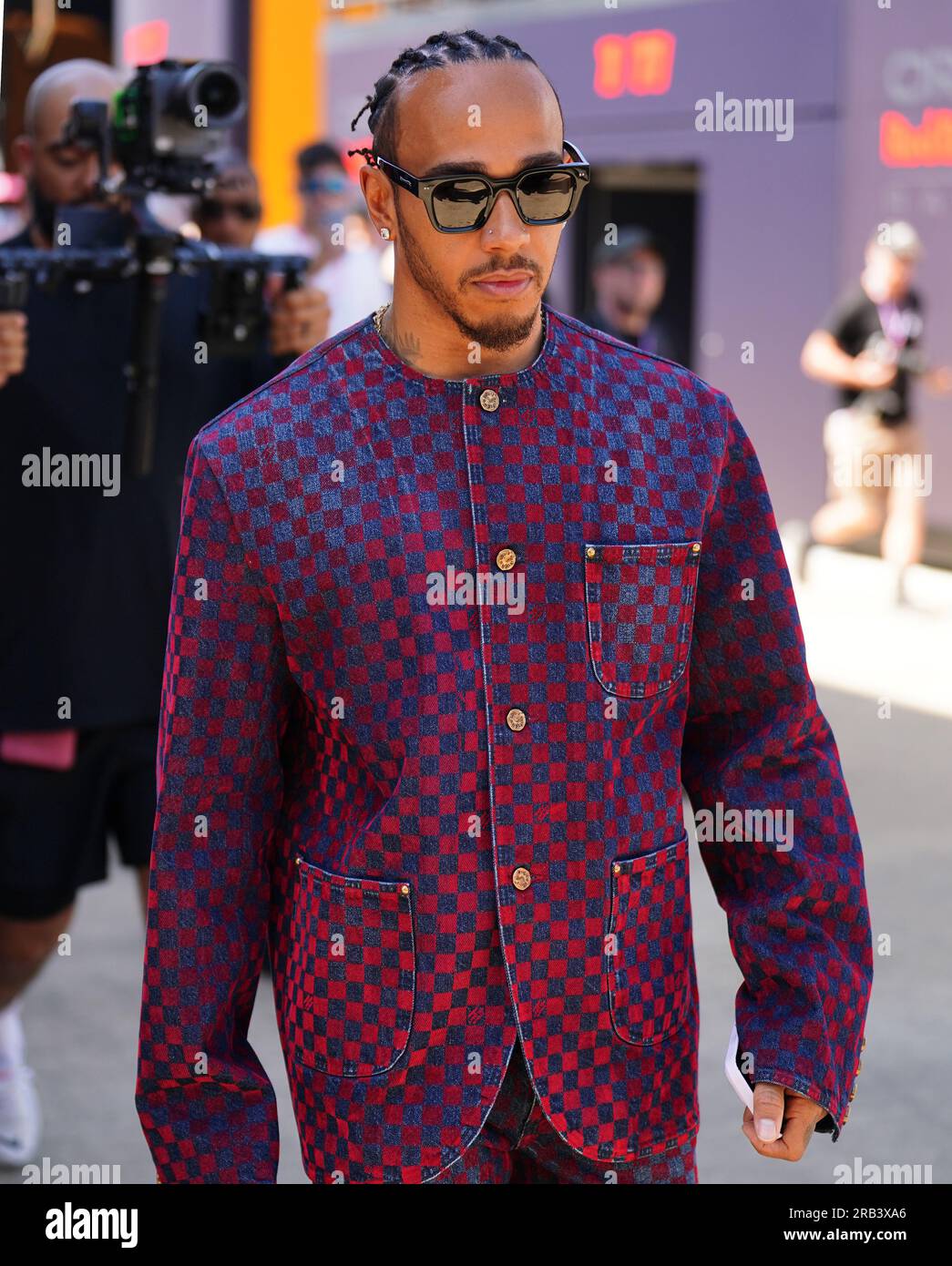 Mercedes' Lewis Hamilton arrives in the paddock on practice day ahead ...