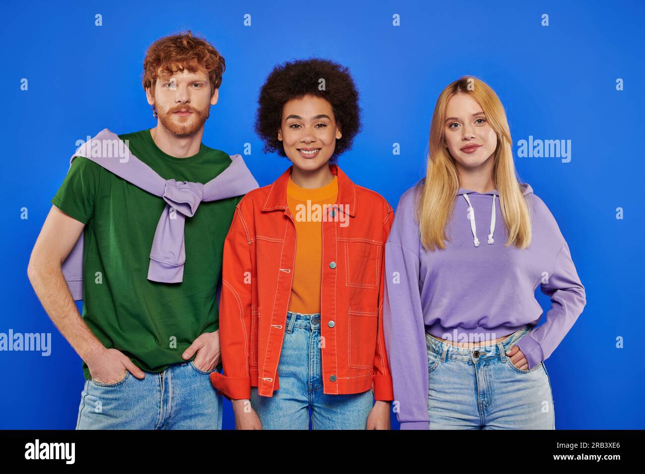 polyamory concept, cheerful multicultural women and redhead man looking ...