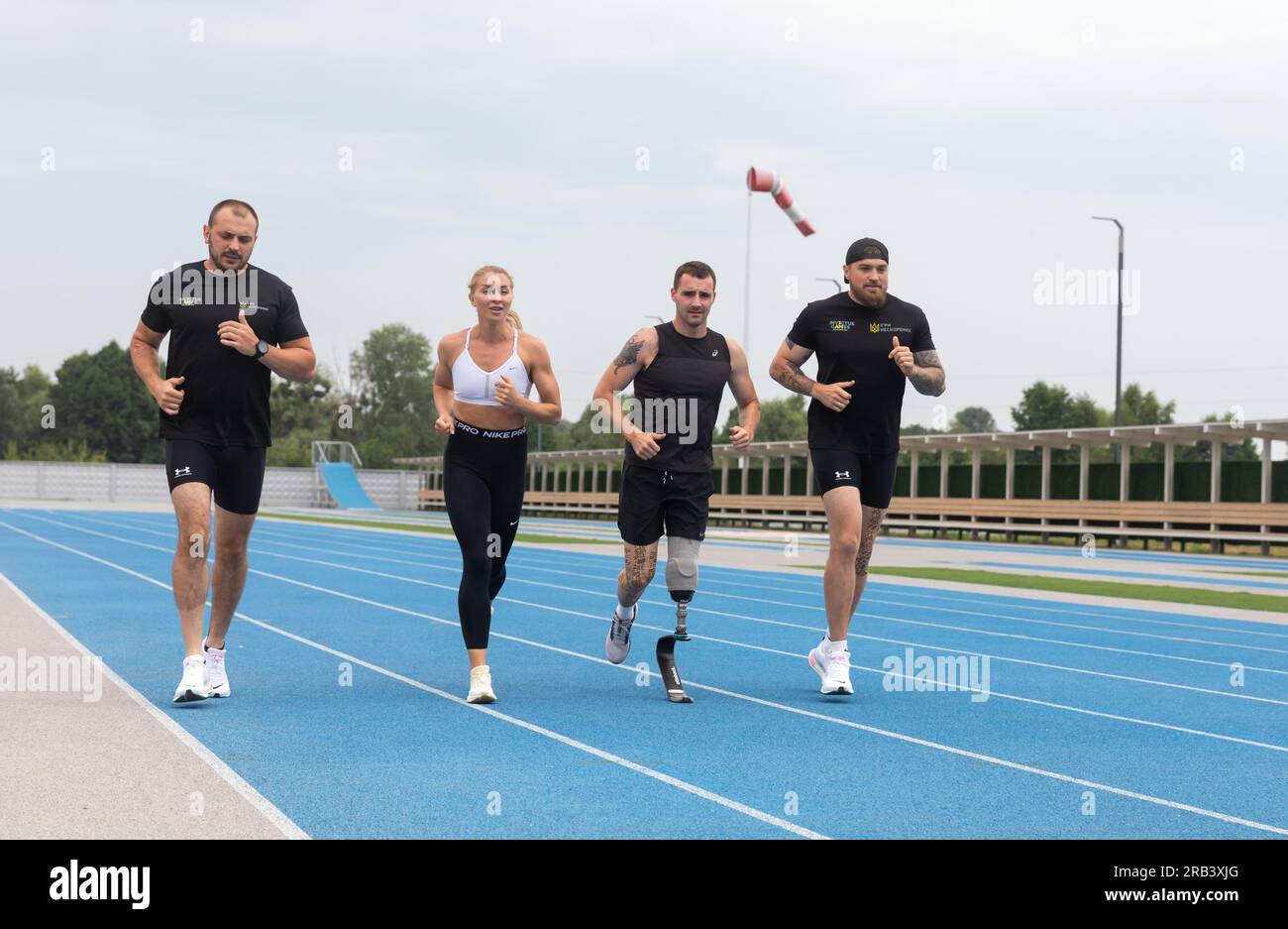 An athlete with a prosthetic leg seen running in a group on a running ...