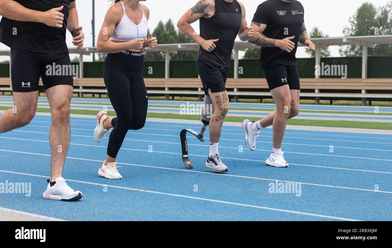 An athlete with a prosthetic leg seen running in a group on a running ...