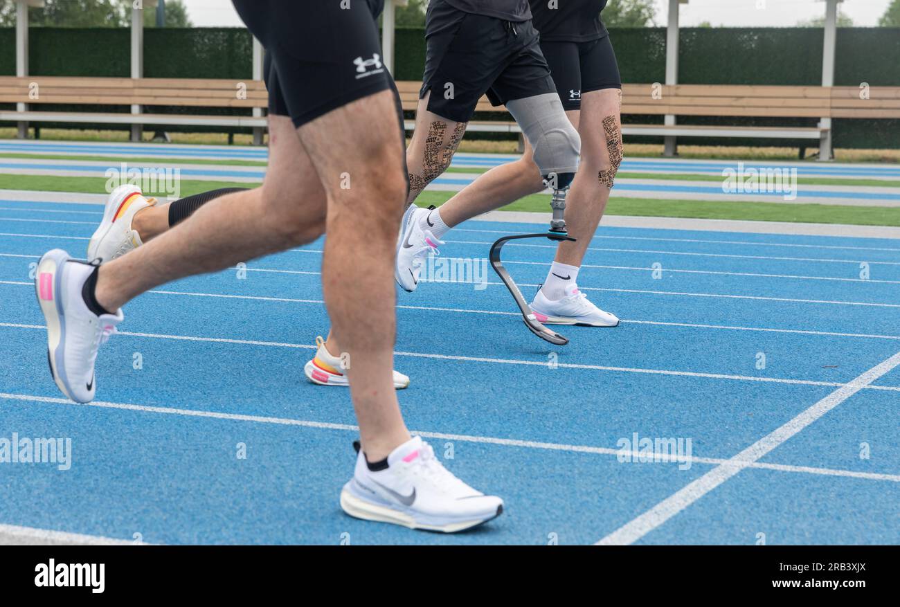An athlete with a prosthetic leg seen running in a group on a running ...