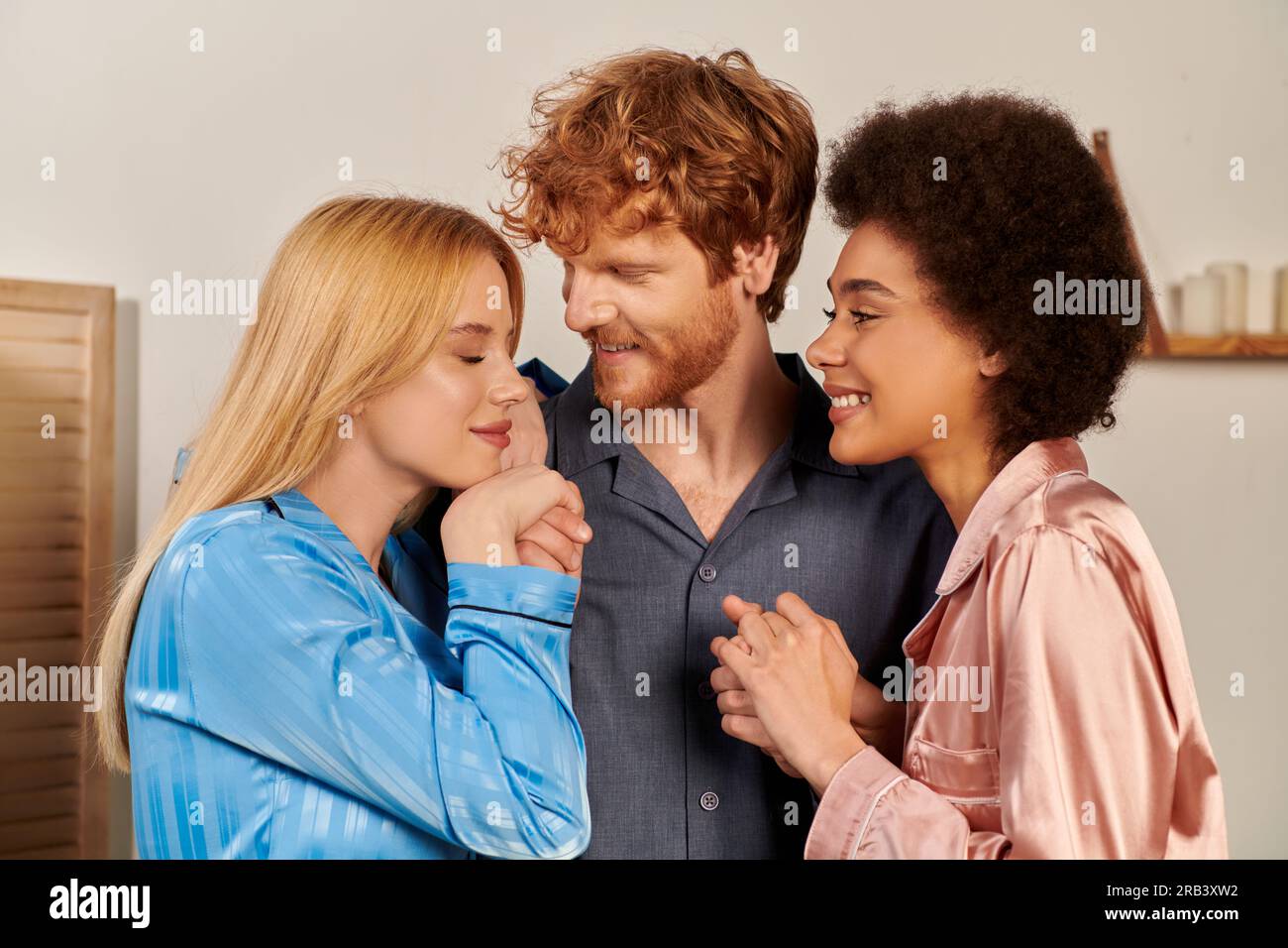polyamory lovers in pajamas, cheerful man with red hair hugging ...