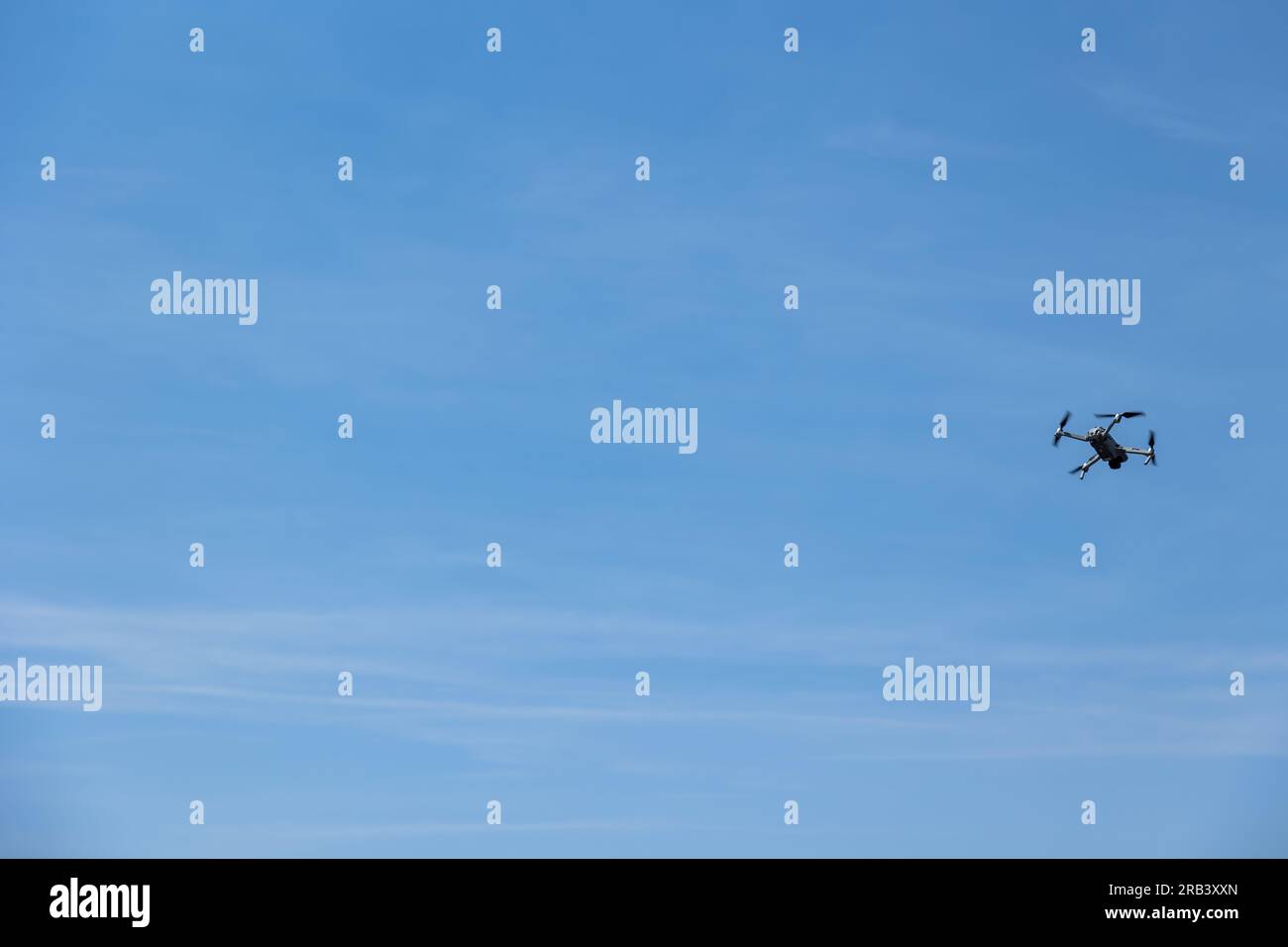 Flying drone in action against the blue sky. Aerial video filming ...