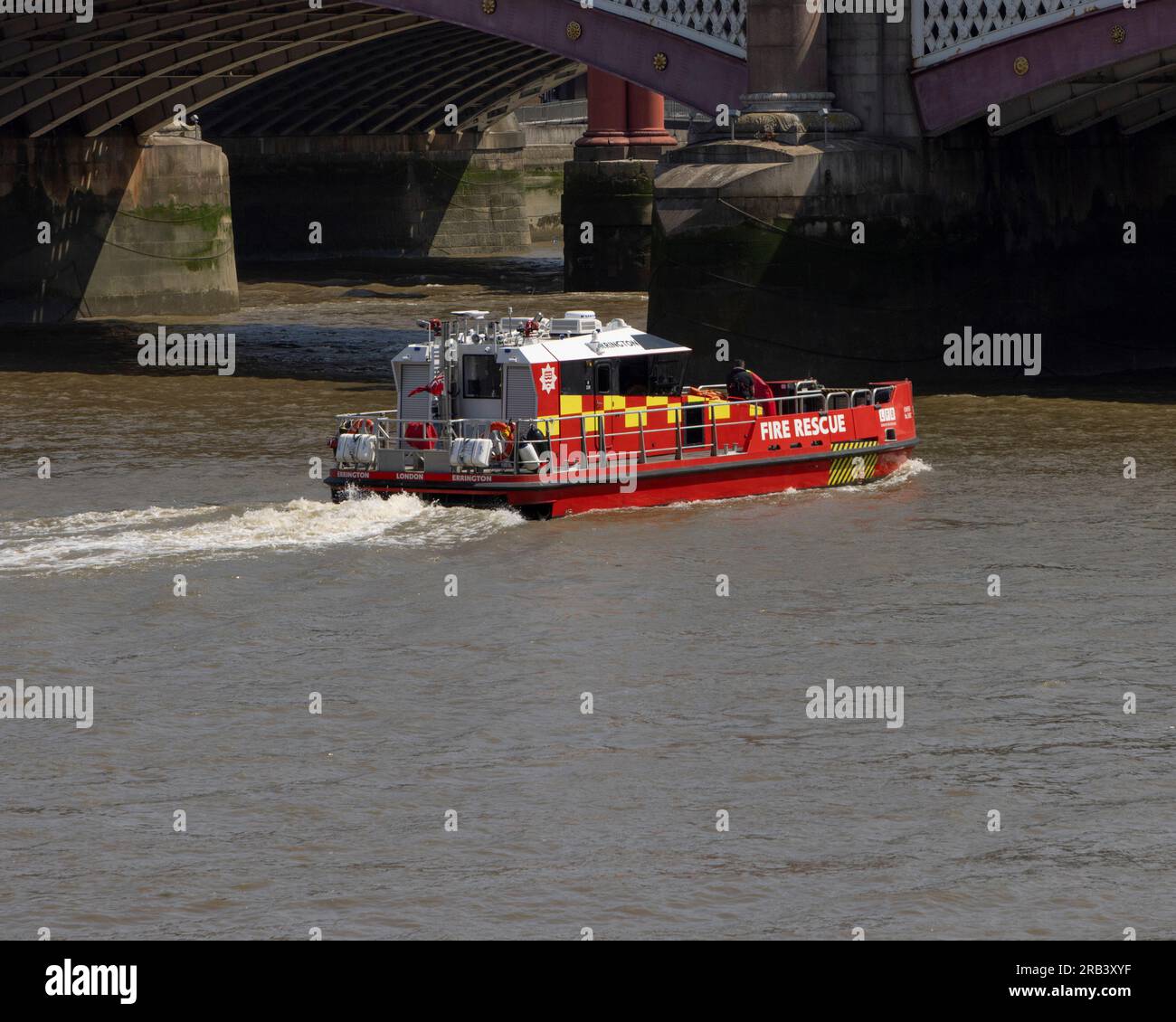 Thames Fire and Rescue boat Errington passes under a bridge on the ...