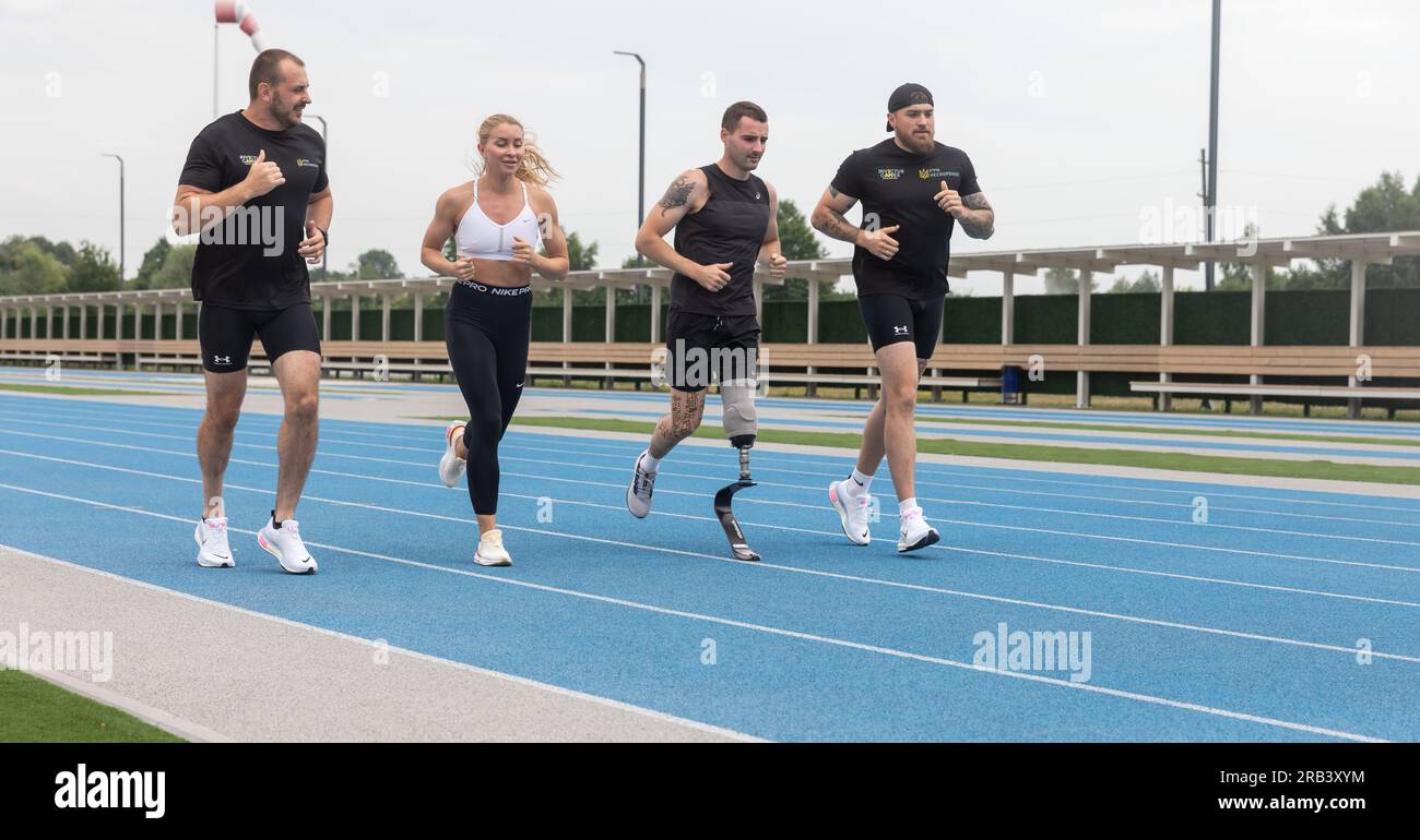 An athlete with a prosthetic leg seen running in a group on a running ...