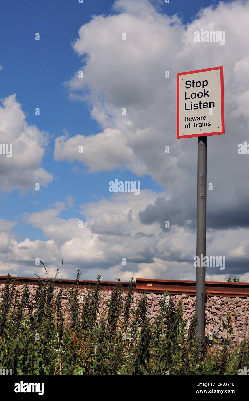 A Stop Look Listen warning sign at a public footpath crossing over a ...