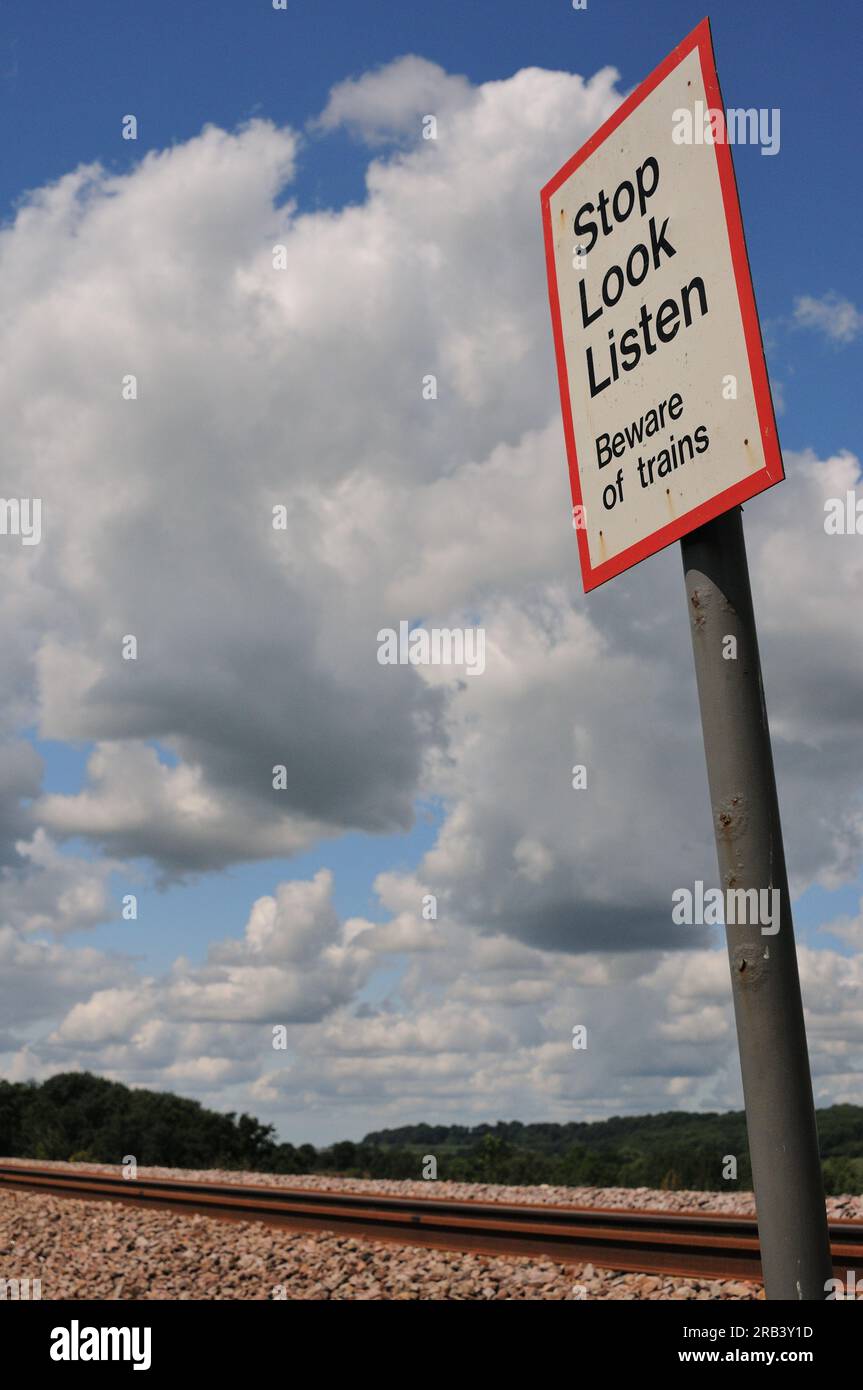 A Stop Look Listen warning sign at a public footpath crossing over a ...