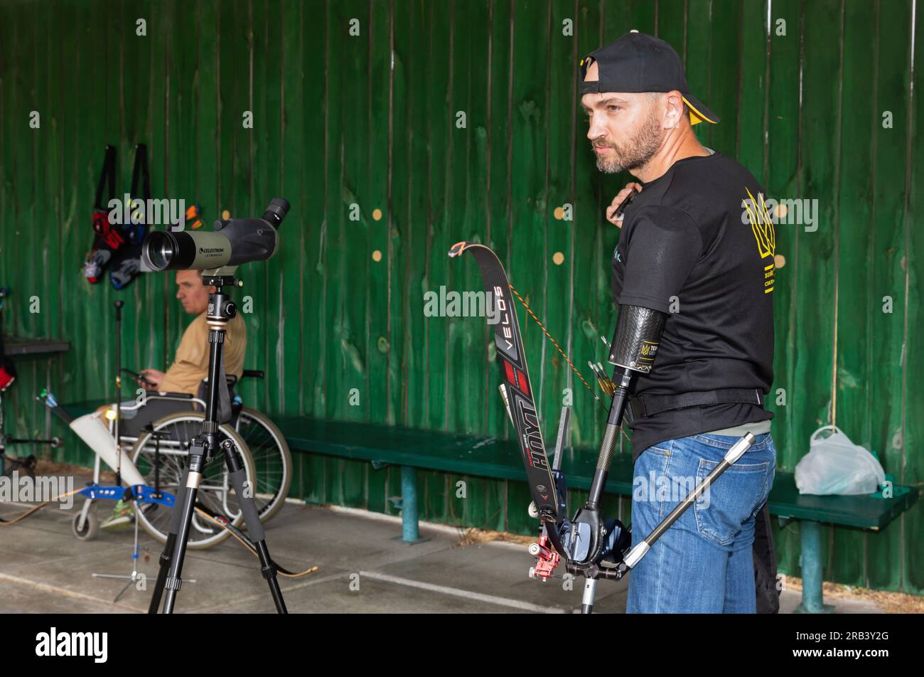 An athlete with a prosthetic arm seen shooting an archer. Training and ...