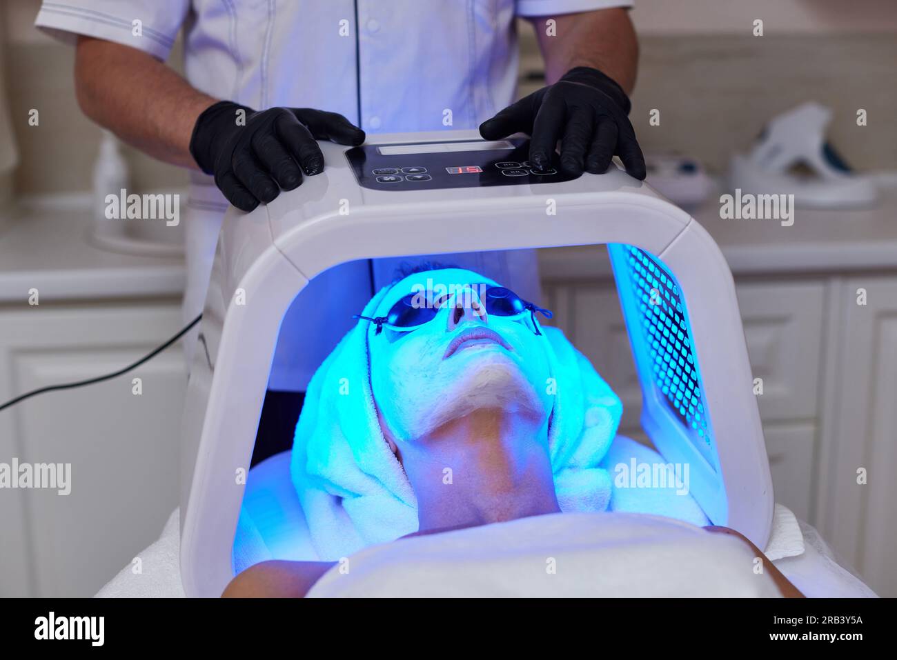 Woman getting facial treatment with led therapy Stock Photo - Alamy