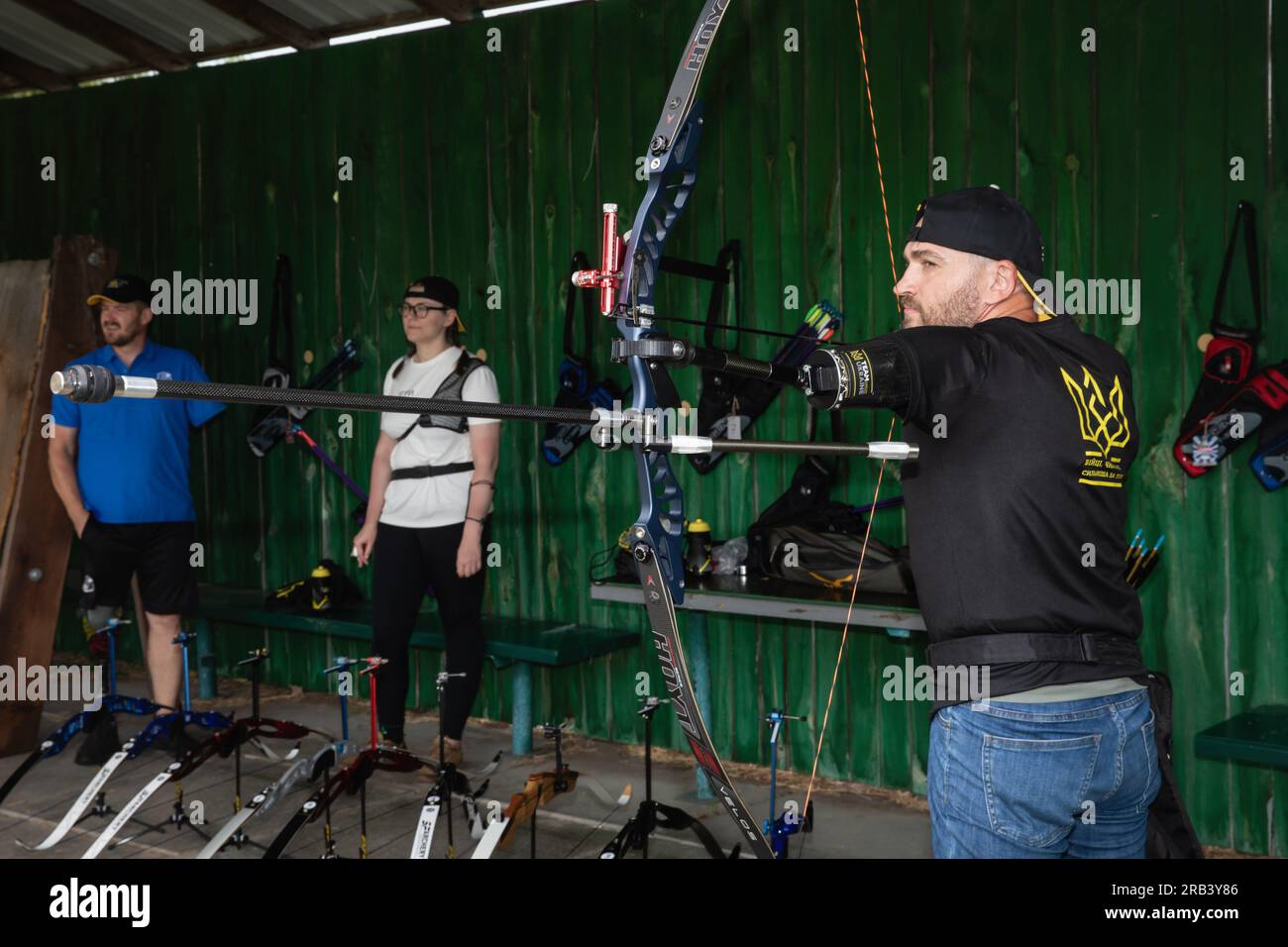 An athlete with a prosthetic arm seen shooting an archer. Training and ...