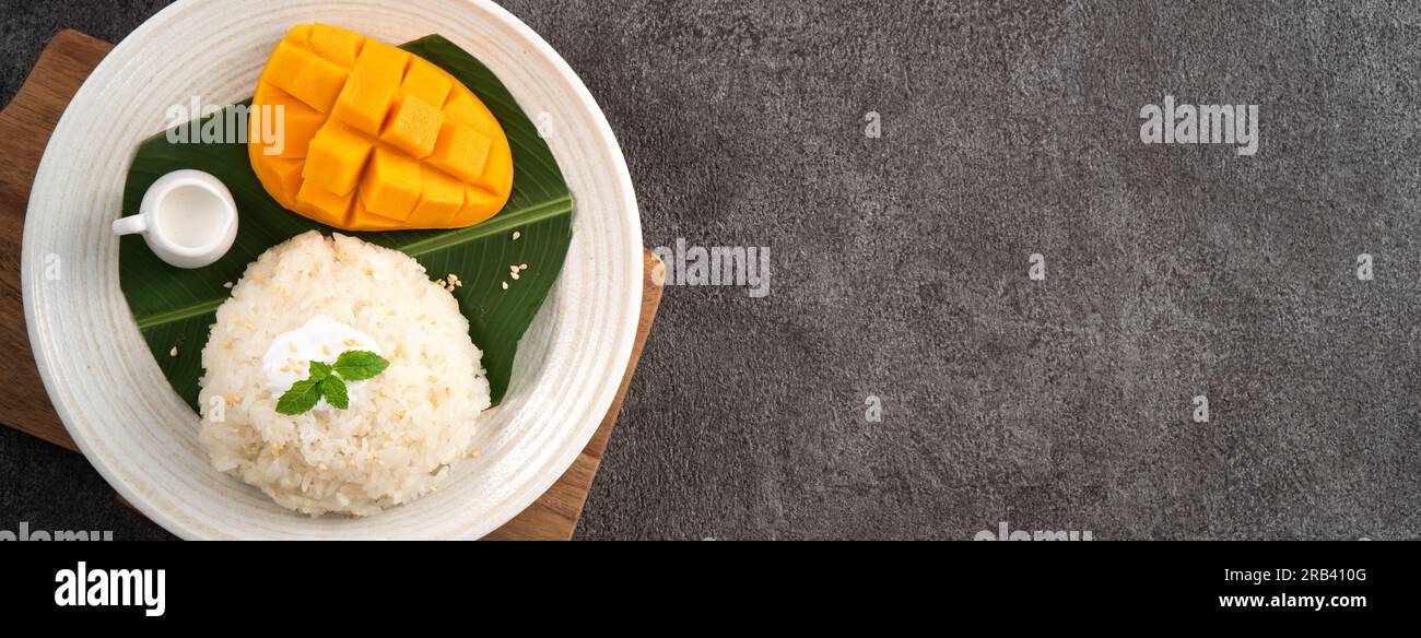 Delicious Thai mango sticky rice with cut fresh mango fruit in a plate ...