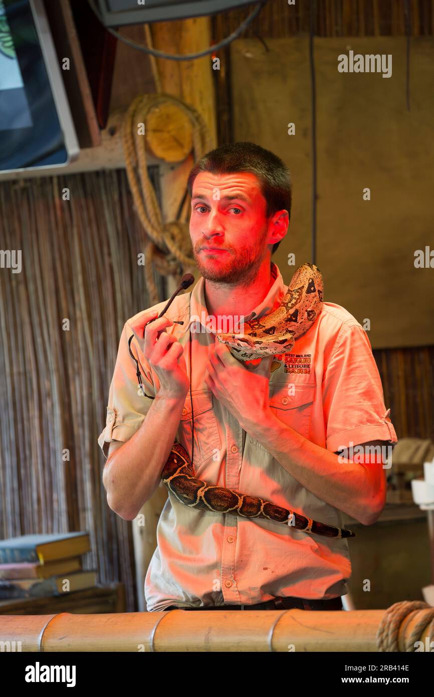 Front view of a reptile expert handler talking about snakes whilst ...