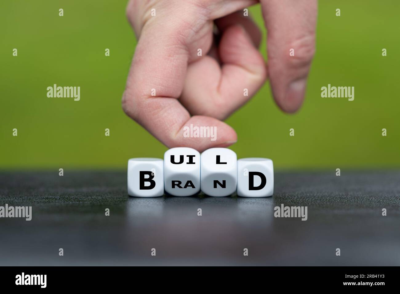 Dice form the words 'build' and 'brand' Stock Photo - Alamy