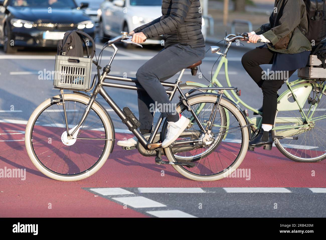 female cyclists on red bike path Stock Photo - Alamy