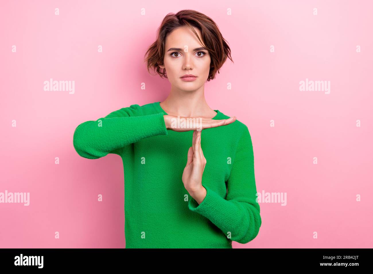Portrait of serious woman football referee demonstrate gesture stop ...