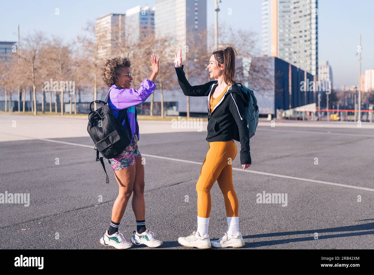 friends shaking hands before running in the city Stock Photo - Alamy