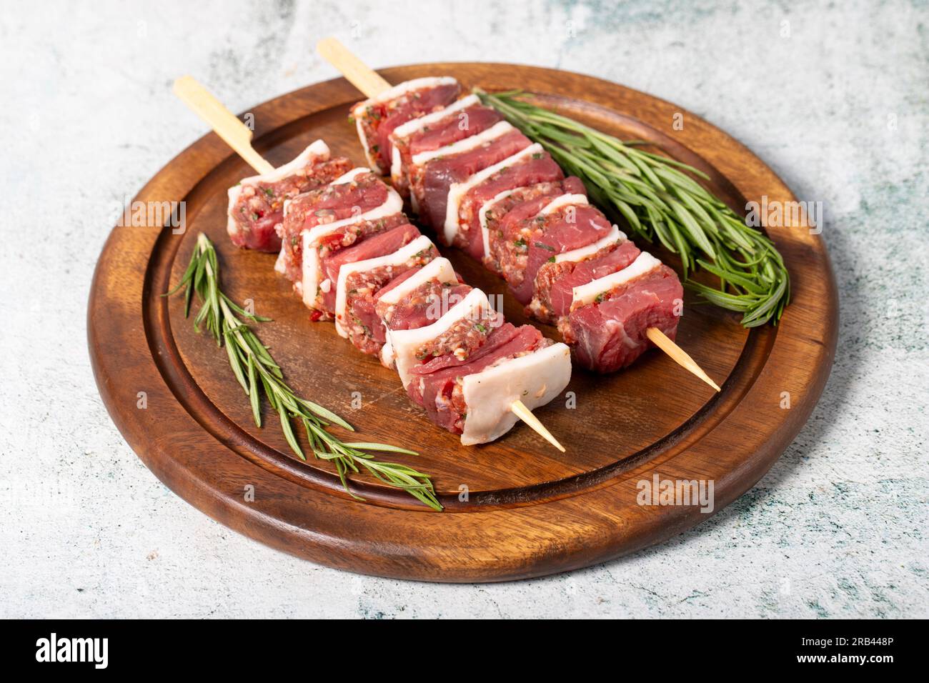 Beef skewer. Shish kebab prepared with raw ribeye and minced meat on a ...