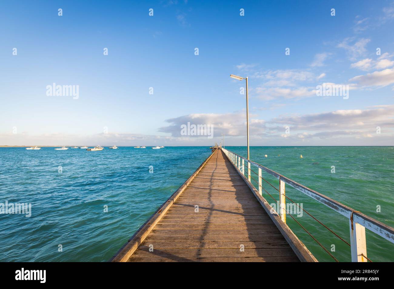 Beachport jetty with fishing boats at sunset, South Australia Stock ...