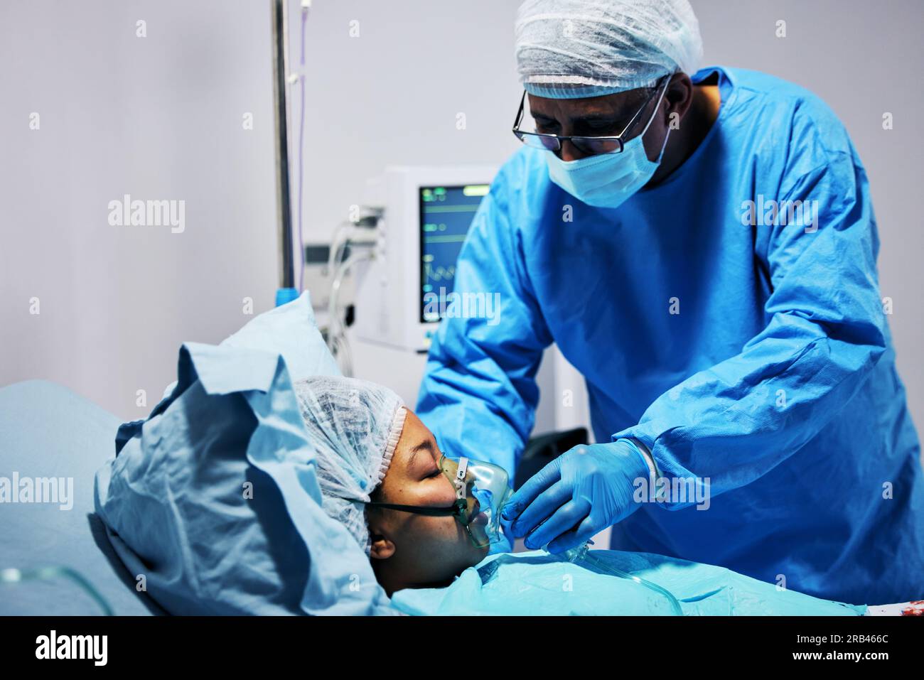 Healthcare, doctor and patient with oxygen in emergency surgery ...