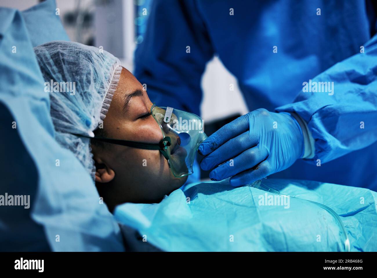 Healthcare, doctor and patient in oxygen mask for surgery, emergency ...