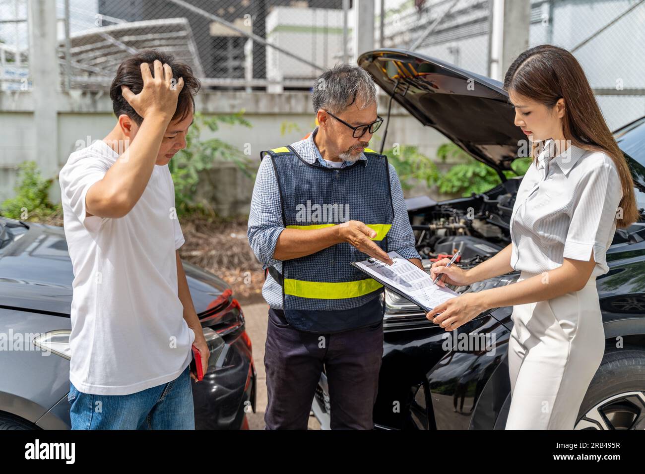 Car insurance agent showing his female client where to sign the ...