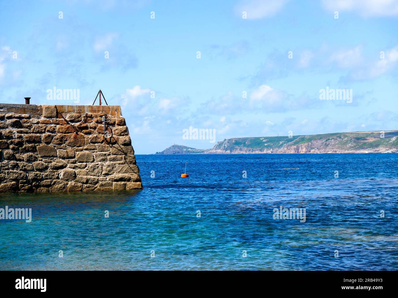 End of the harbour wall at Sennen Cove, with an orange buoy and view of ...