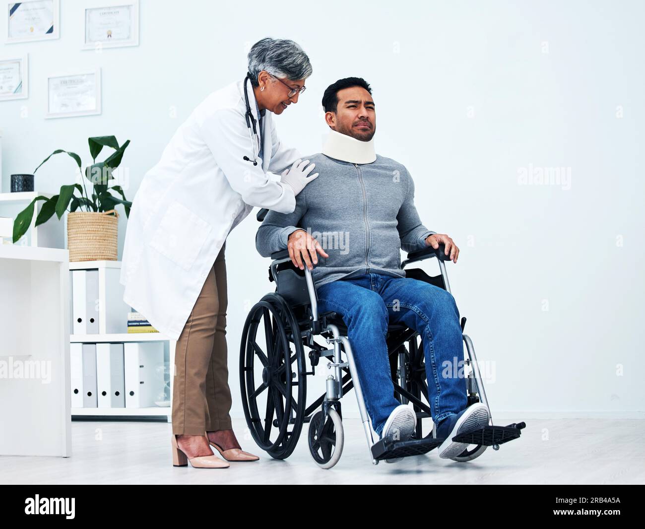 Hospital, injury and doctor with man in wheelchair for medical ...