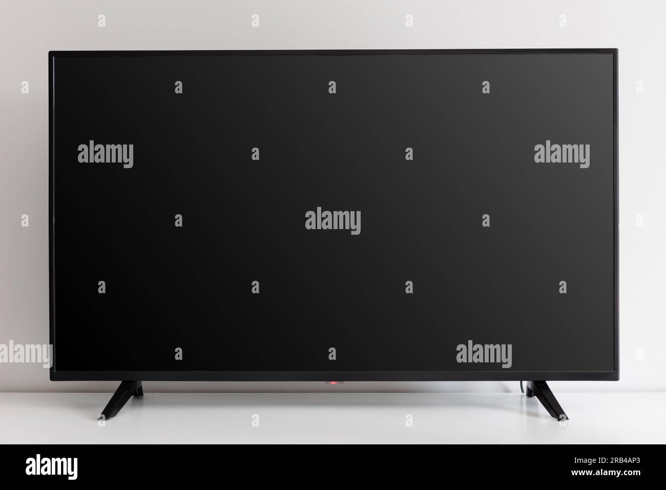 Blank black tv screen on white commode against white wall Stock Photo ...