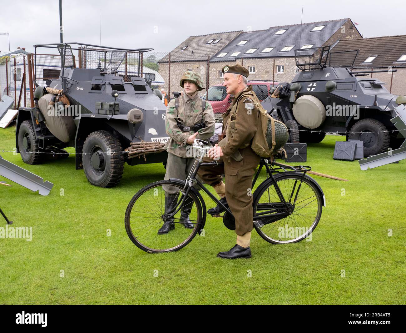 German armoured vehicles and a soldier on an old bike at the 1940's ...
