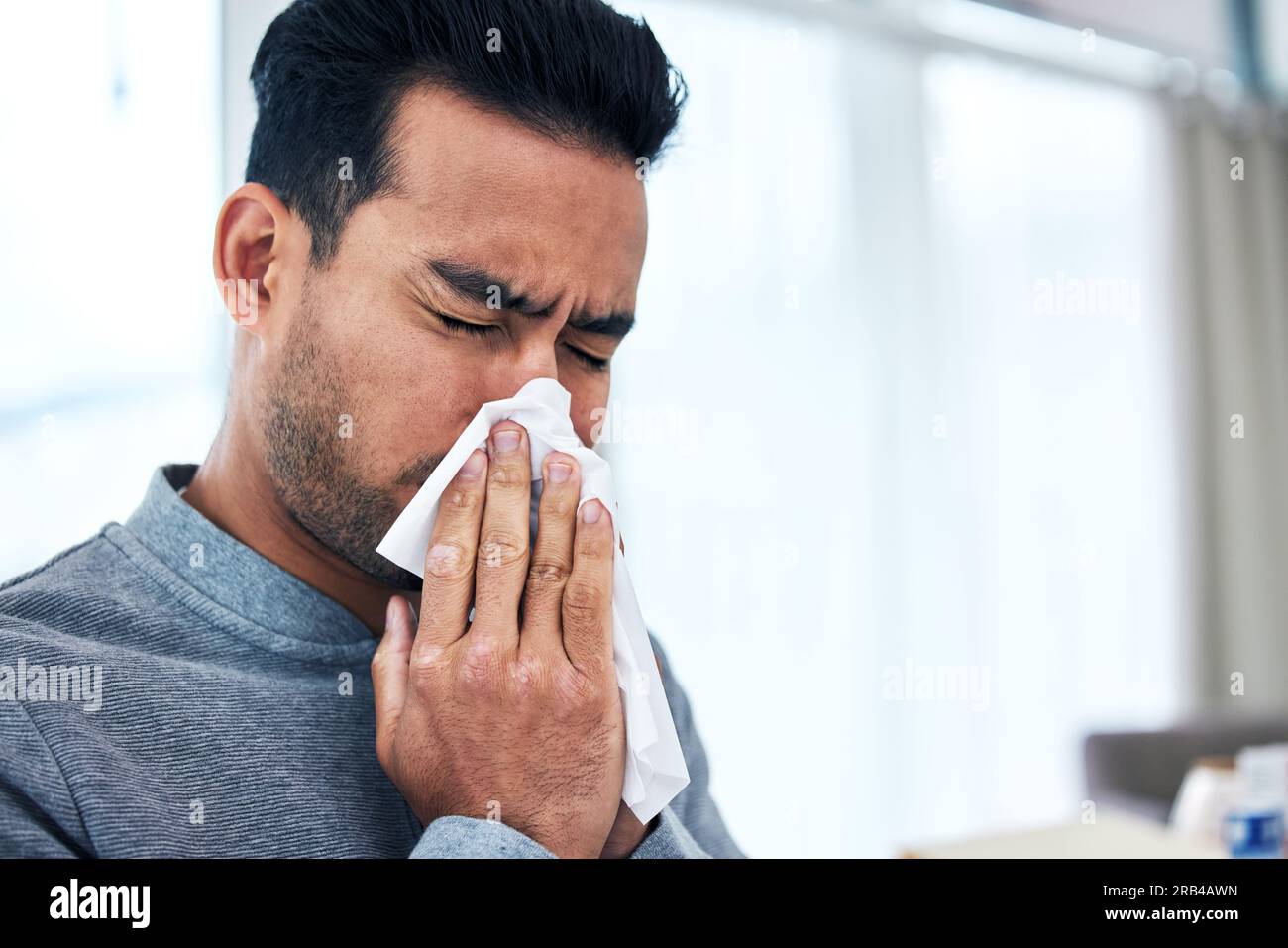 Blowing nose, sick and man with tissue for allergies, hayfever and ...