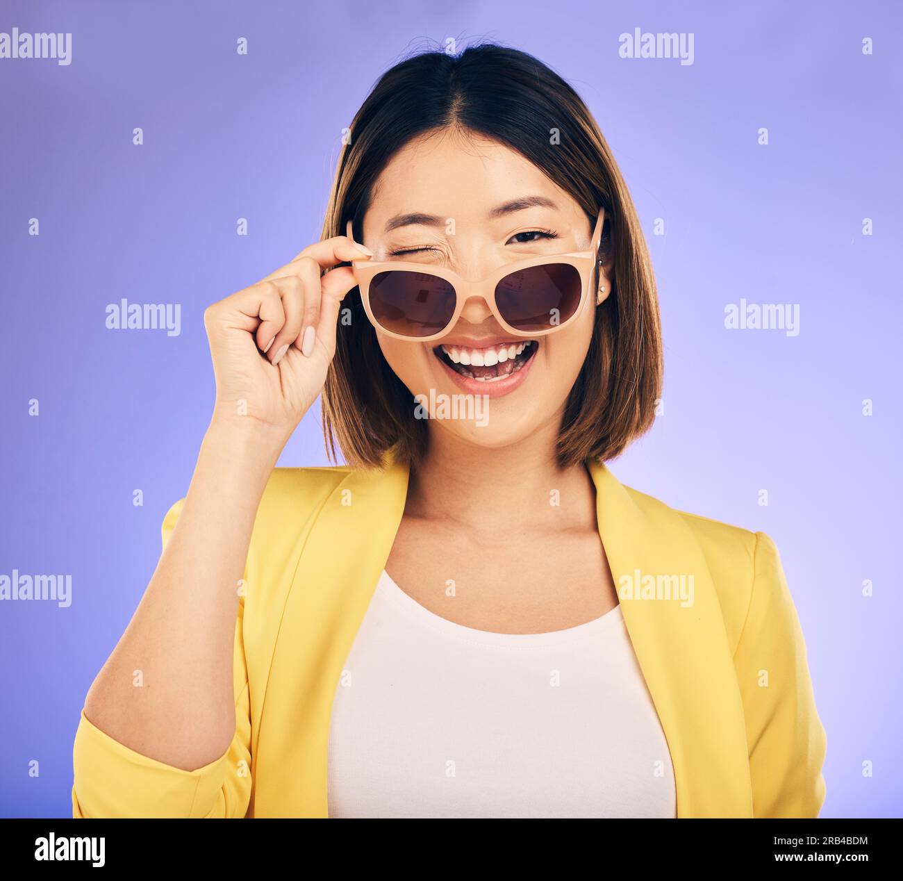 Happy, portrait of asian woman wink with glasses in studio, purple ...