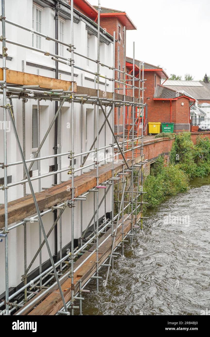Scaffolding across a building in water Stock Photo - Alamy