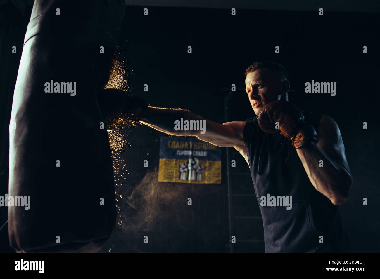 Muscular man hitting punching bag hi-res stock photography and images ...