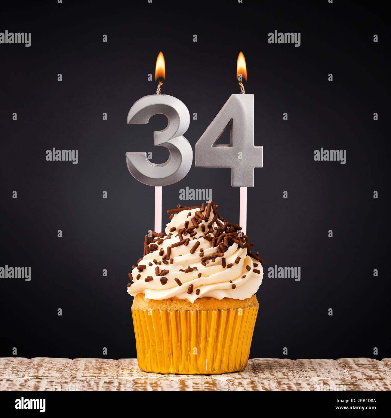 birthday cupcake with number 34 candle - Celebration on dark background ...