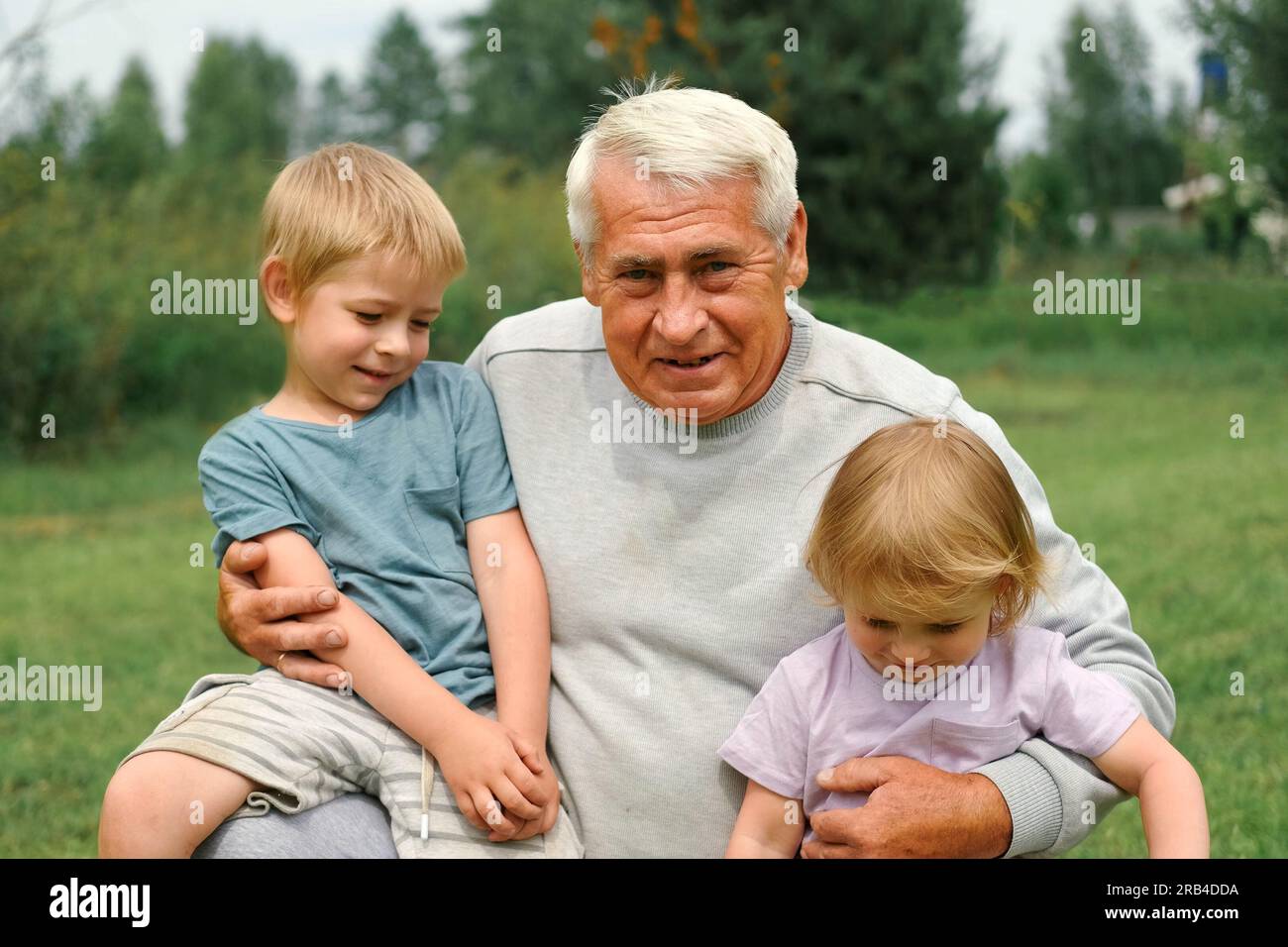 Grandfather and grandchildren have fun during walk In Park. Happy ...