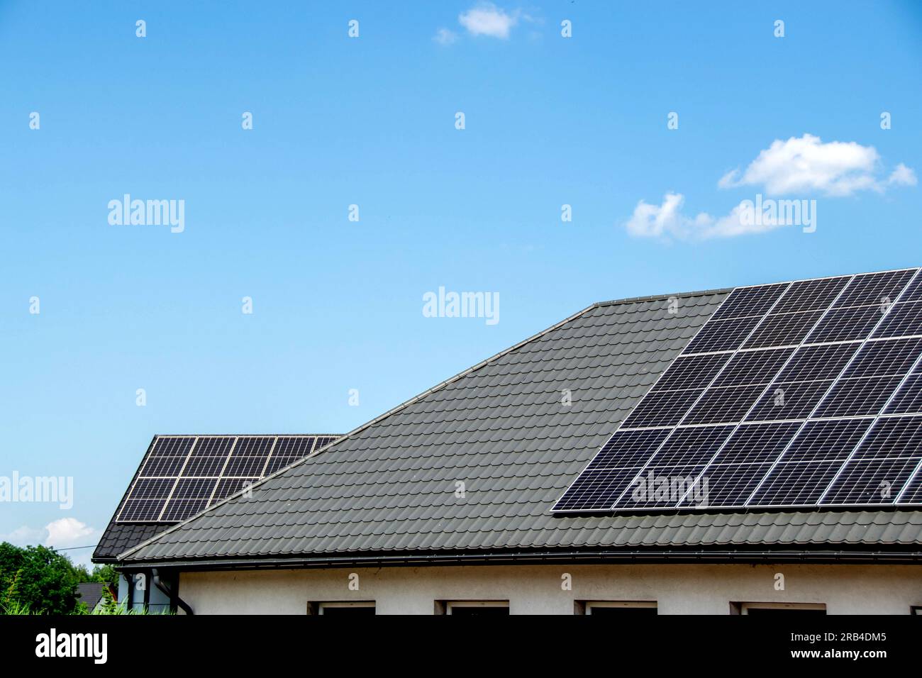 House roof with photovoltaic modules. Historic farm house with modern ...