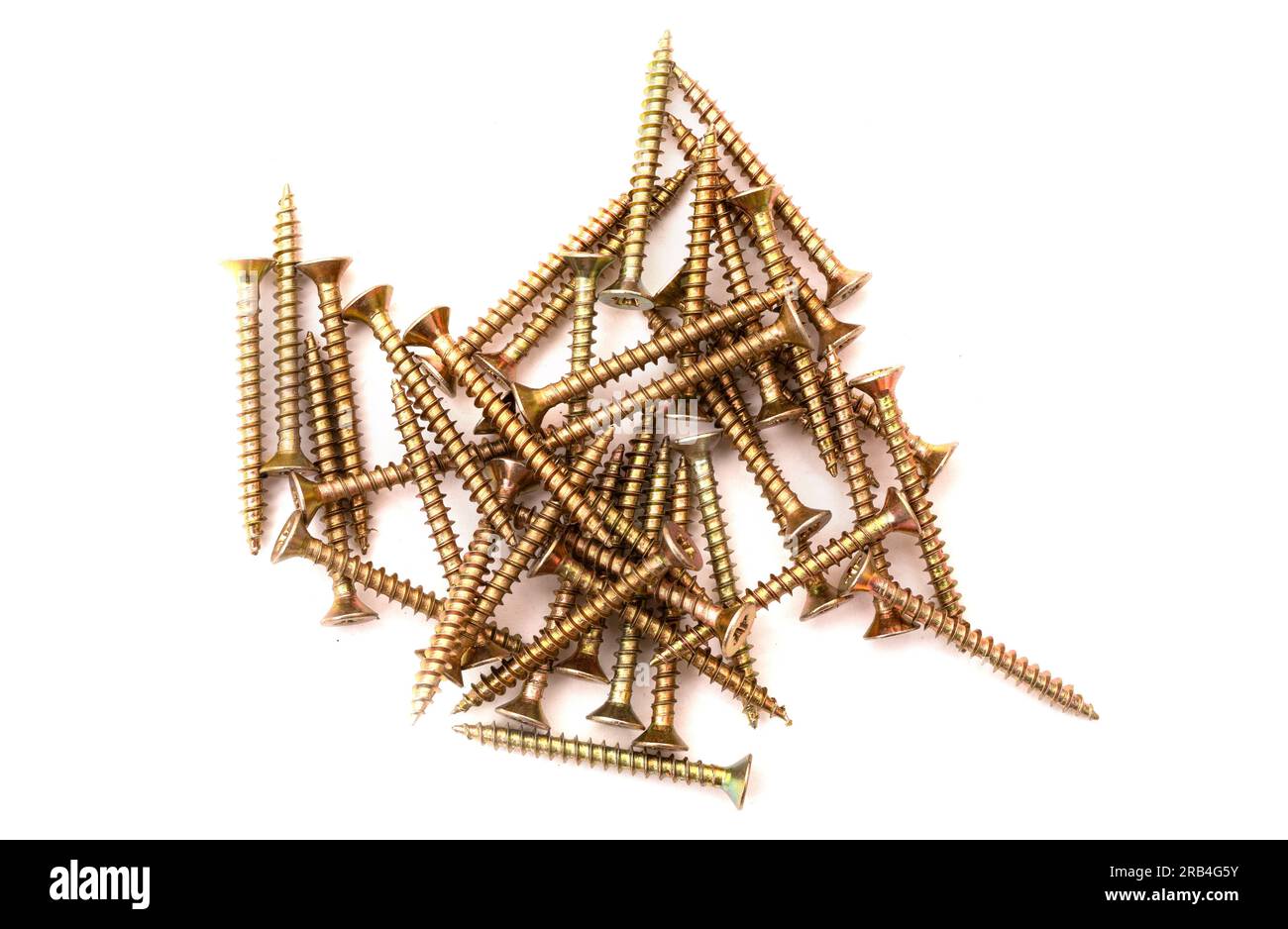 Pile of yellow self-tapping screws on a white background Stock Photo ...