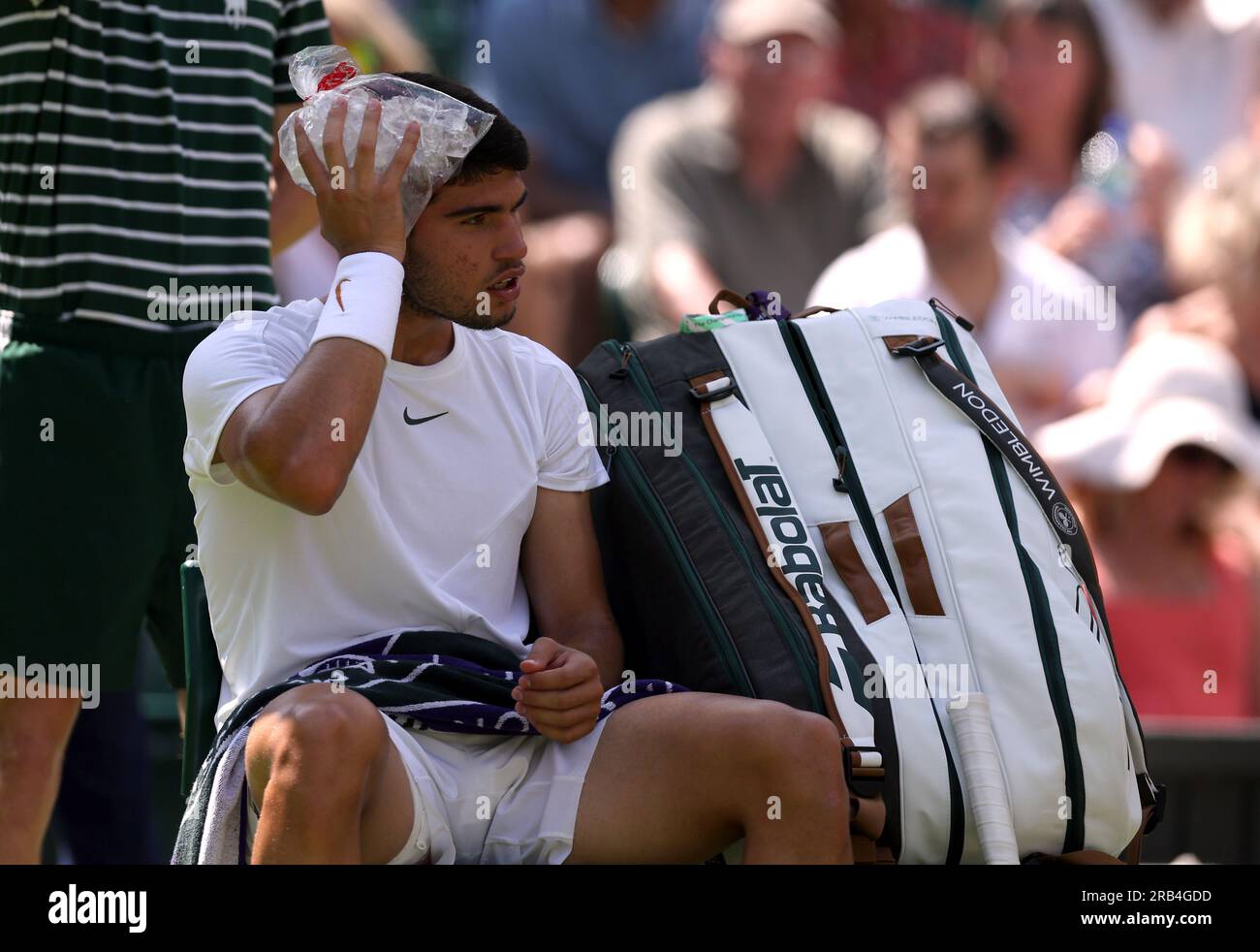 Carlos Alcaraz cools down with a bag of ice during his match against ...