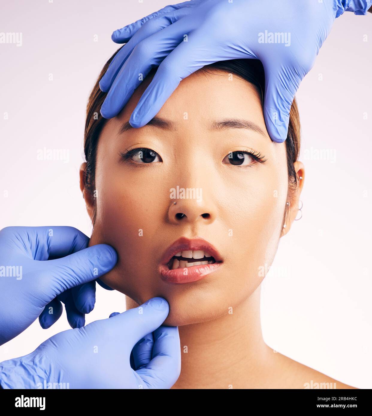 Asian woman, surgery and pinch facial skin in studio for cosmetic ...