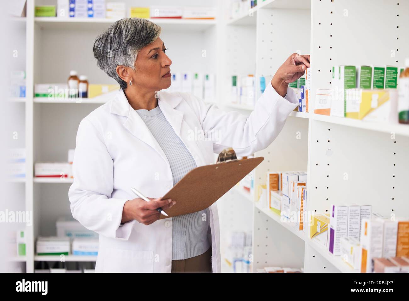 Pharmacy, writing and clipboard of woman with medicine on a shelf for ...